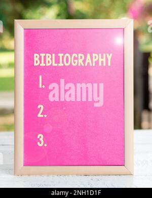 Hand writing sign Bibliography. Business overview a list of writings ...