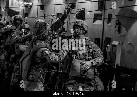 A jumpmaster checks a Paratrooper's static line during sustained ...