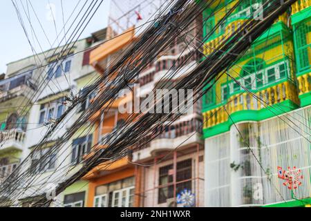 Intertwined electric wires in front of buildings which is the first ...