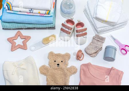 Concept of giving birth. Set of clothes and accessories for newborn on ...