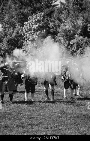 Colonial soldiers in a cloud of smoke fire their muskets at Red Coats ...