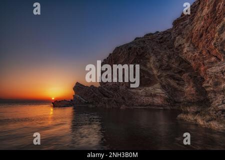 Sun setting behind the Cala Rossa cliff, Terrasini Stock Photo - Alamy