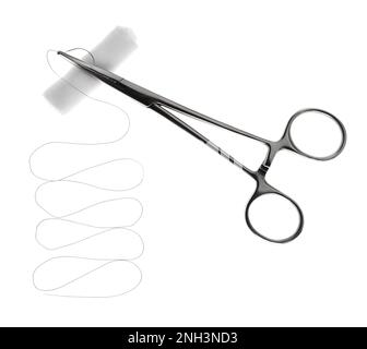 Forceps with suture thread and bandage roll on white background ...