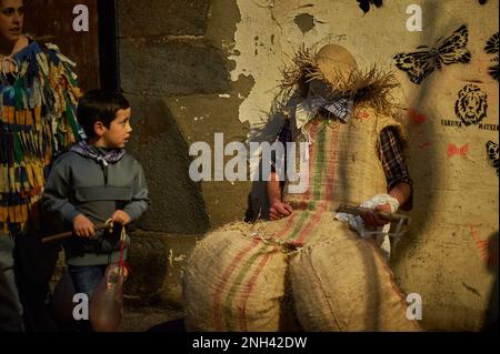 A child looks at a "zaku-zaharrak" while it rests on the wall of a ...