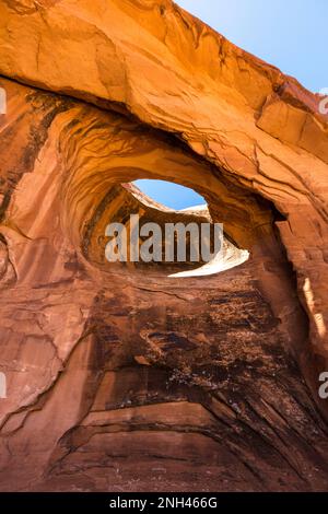 Cummings Arch is a pothole arch south of Moab, Utah. A pothole arch has ...