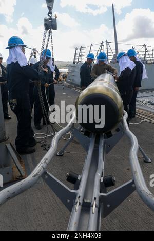 U.S. Sailors load an MK 46 torpedo aboard the guided missile destroyer ...