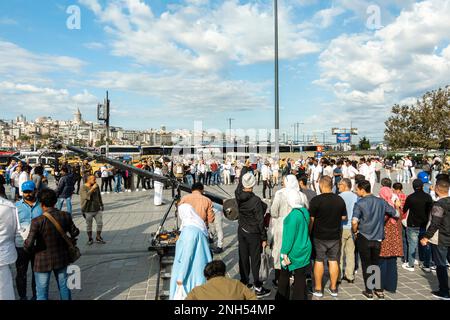 Filming in Istanbul Turkey. Big crew in white clothing on the fim set ...