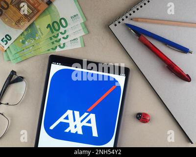 In this photo illustration, the AXA company logo is seen displayed on a ...