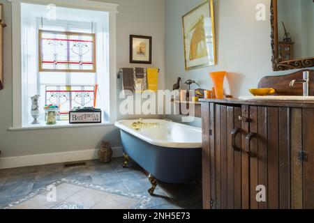 Freestanding claw foot bathtub and vanity in bathroom inside extension ...