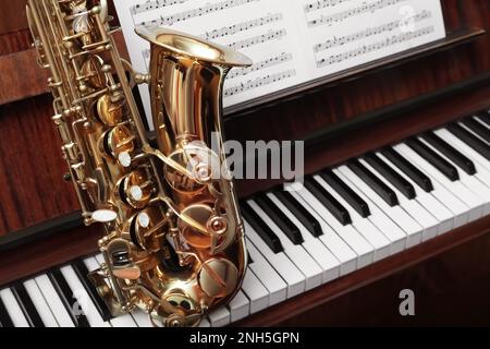 Beautiful saxophone on piano keys. Musical instruments Stock Photo - Alamy