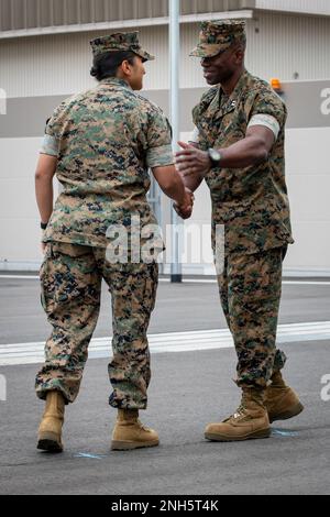 U.S. Marine Corps Capt. Alusine Kamara, right, passes a guidon to 1st ...