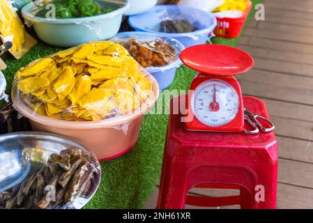 scales in the Vietnamese market for weighing dried fruits and snacks ...