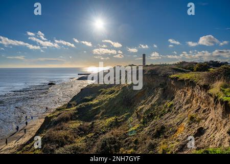 Looking out into the North Sea with the eroding cliffs of Walton on the ...