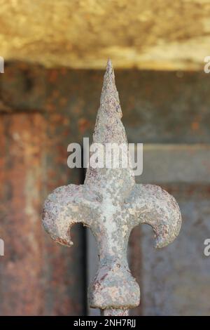A sharp pointy and rusty decoration on an old vintage fence in a black ...