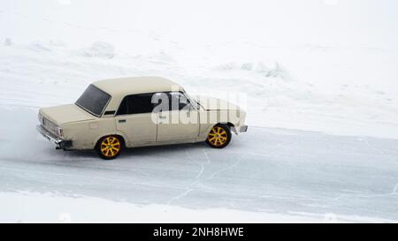 Russian old cars "VAZ Zhiguli" are driving fast in a drift on a snowy ...