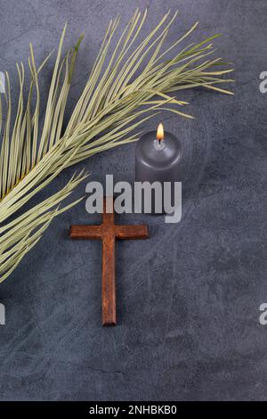 Catholic Cross with palm leaf and burning candle. Ash Wednesday, Lent ...