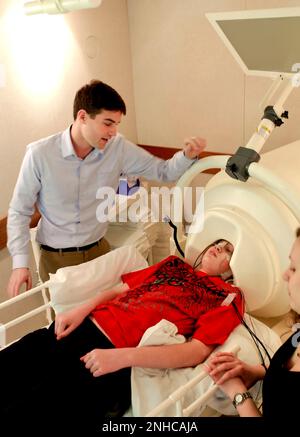 14-year-old Christopher Mahar, is prepared for a magnetoencephalography ...