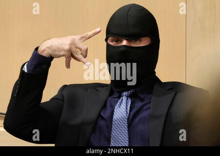 Broward Sheriff's Office Detective Danny Polo, whose face is concealed ...