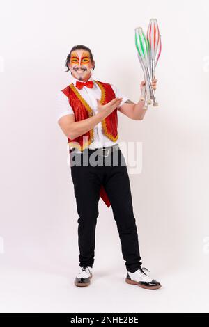 Smiling juggler juggling isolated on white background Stock Photo - Alamy