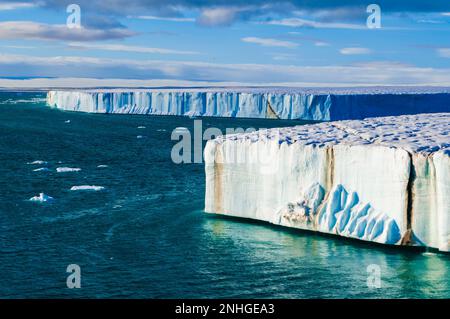 Water pouring off the arctic ice shelf of the Svalbard Islands of ...