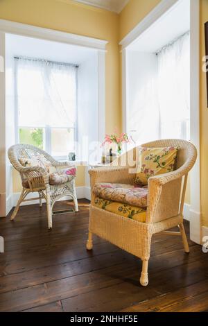 Cozy room with armchairs and a round table with a bowl of fresh fruit ...