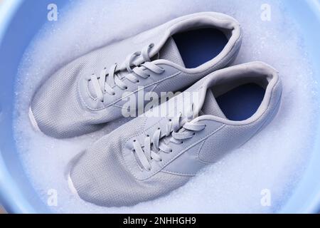 Washing sport shoes in plastic basin, top view Stock Photo - Alamy