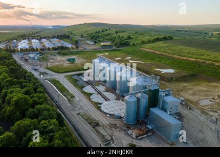 Aerial view of industrial ventilated silos for long term storage of grain and oilseed. Metal ...