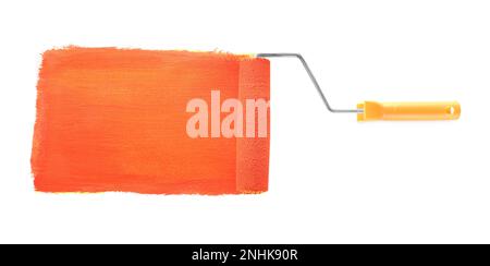 Applying coral paint with roller brush on white background, top view ...