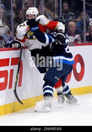 Winnipeg Jets' Michael Eyssimont (23) checks Florida Panthers' Josh ...
