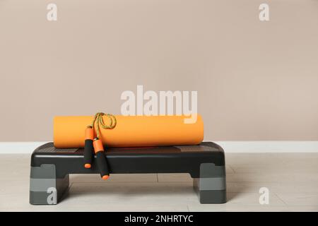 Step platform, mat and jump rope on white background. Sports equipment ...