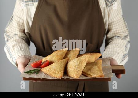 Delicious samosas on grey background Stock Photo - Alamy