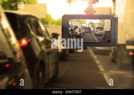 Modern dashboard camera mounted in car, view of road during driving ...