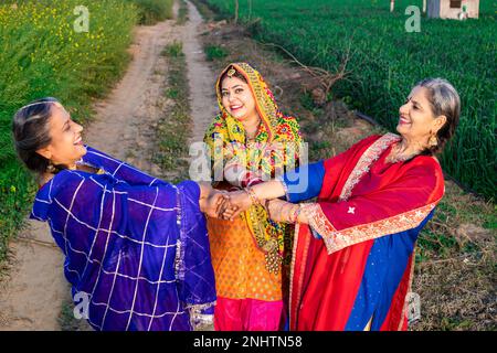 Group of Punjabi women wearing colorful traditional dress dancing ...