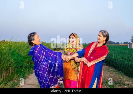 Group of Punjabi women wearing colorful traditional dress dancing ...