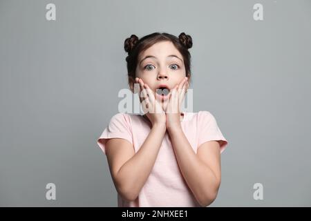Little girl feeling fear on grey background Stock Photo - Alamy
