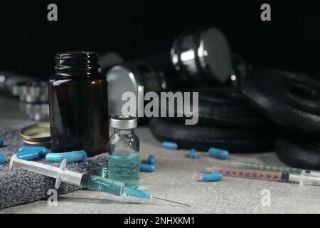 Different drugs and sports equipment on turquoise background, closeup ...