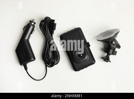 Modern car dashboard camera, suction mount and charger on dark green ...