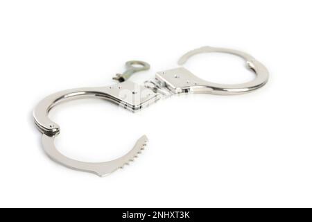 Classic chain handcuffs with key on white background Stock Photo - Alamy