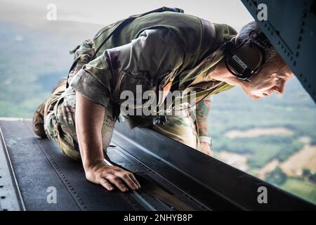 U.S. Army Maj. Jett Nelson, with the 56th Troop Command, gives a Ch-47 ...
