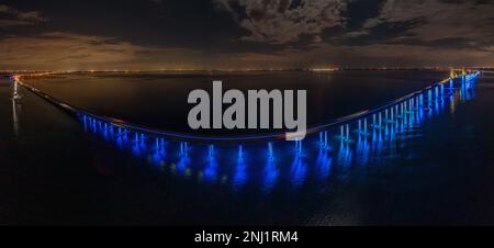 Night drone panorama of Sunshine Skyway Bridge with colorful ...