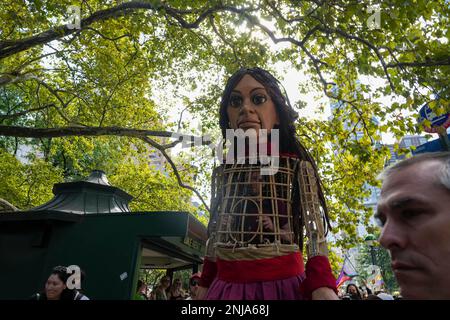 The 12-foot puppet known as "Little Amal" walks through Times Square as ...