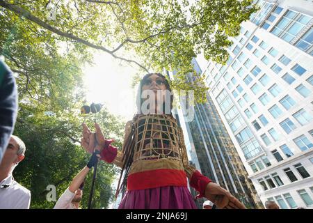 The 12-foot puppet known as "Little Amal" walks through Times Square as ...
