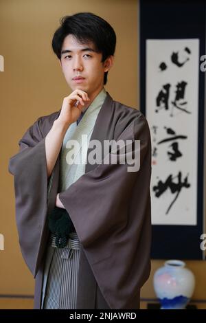 Shogi player Sota Fujii poses in front of a paper lantern with the ...