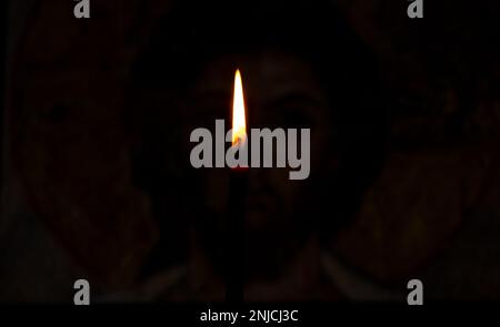 burning candle illuminates the icon of Jesus Christ Stock Photo - Alamy