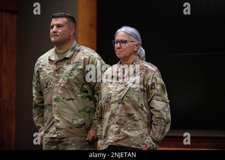 Chief Warrant Officer (4) Peggy Bates hugs friends after her retirement ...