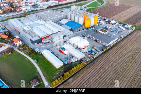 Drone shot of an industrial lot with some trucks, warehouses, a factory ...