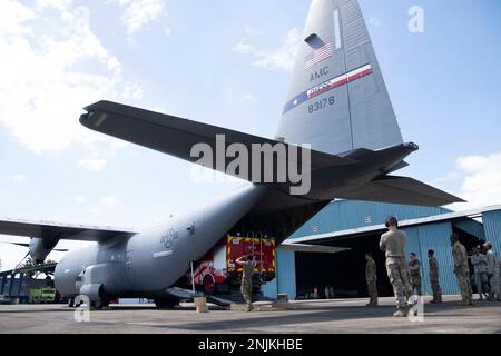 U.S. Airmen unload a P-34 Rapid Intervention Vehicle from a C-130J ...