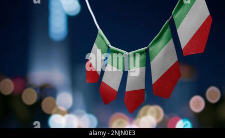 A garland of Italy national flags on an abstract blurred background ...