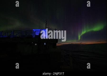 The aurora borealis is seen, with lingering sunlight at 0130 in the ...