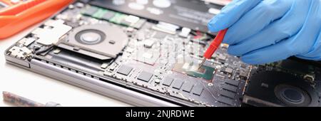 Technician measures the voltage on motherboard of computer electronic ...